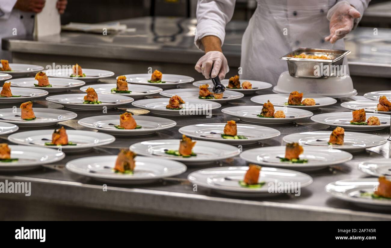 A helper prepares the food for the passengers in a kitchen of the ...