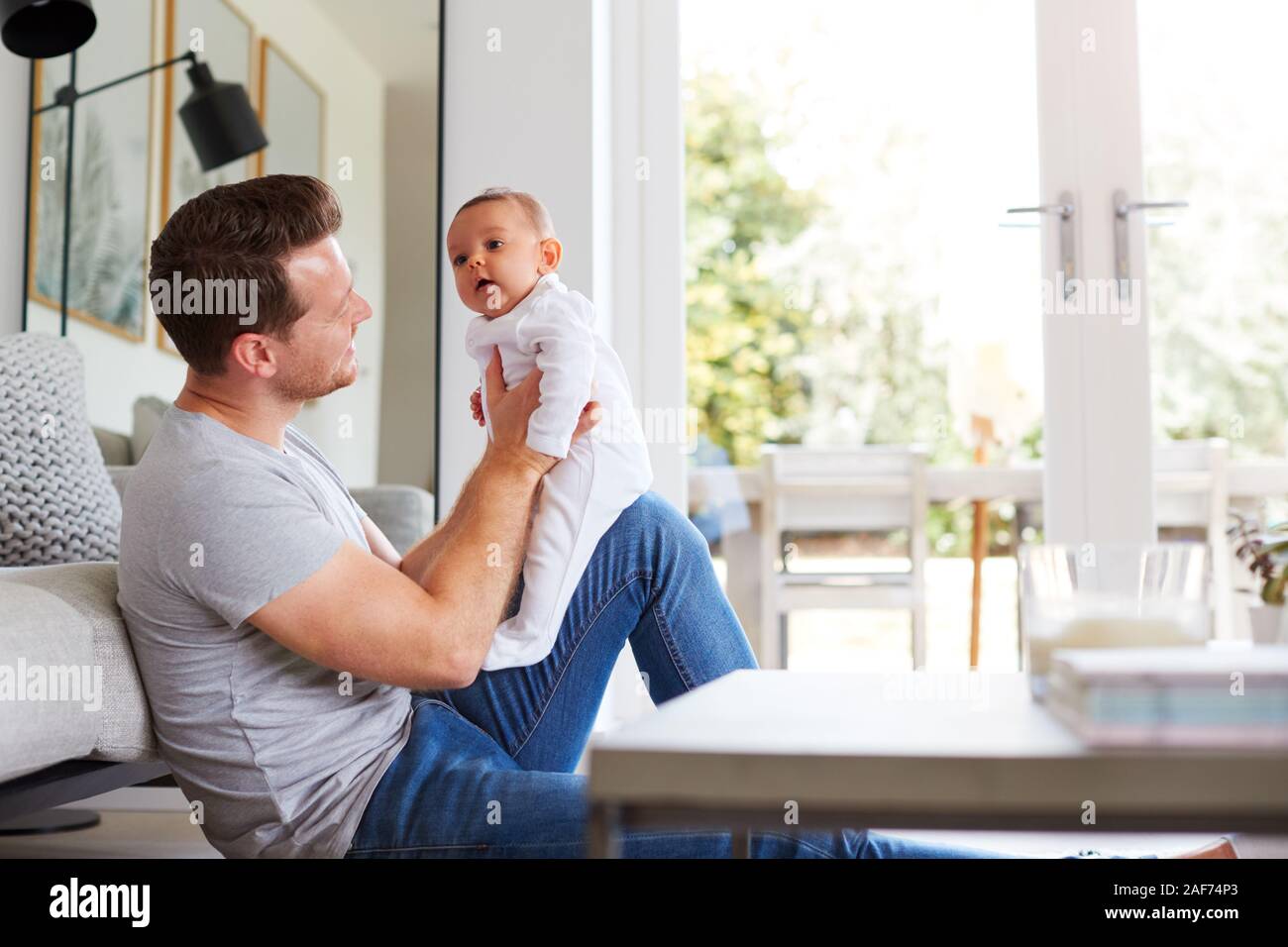 Daughter sitting on fathers lap hi-res stock photography and images - Alamy