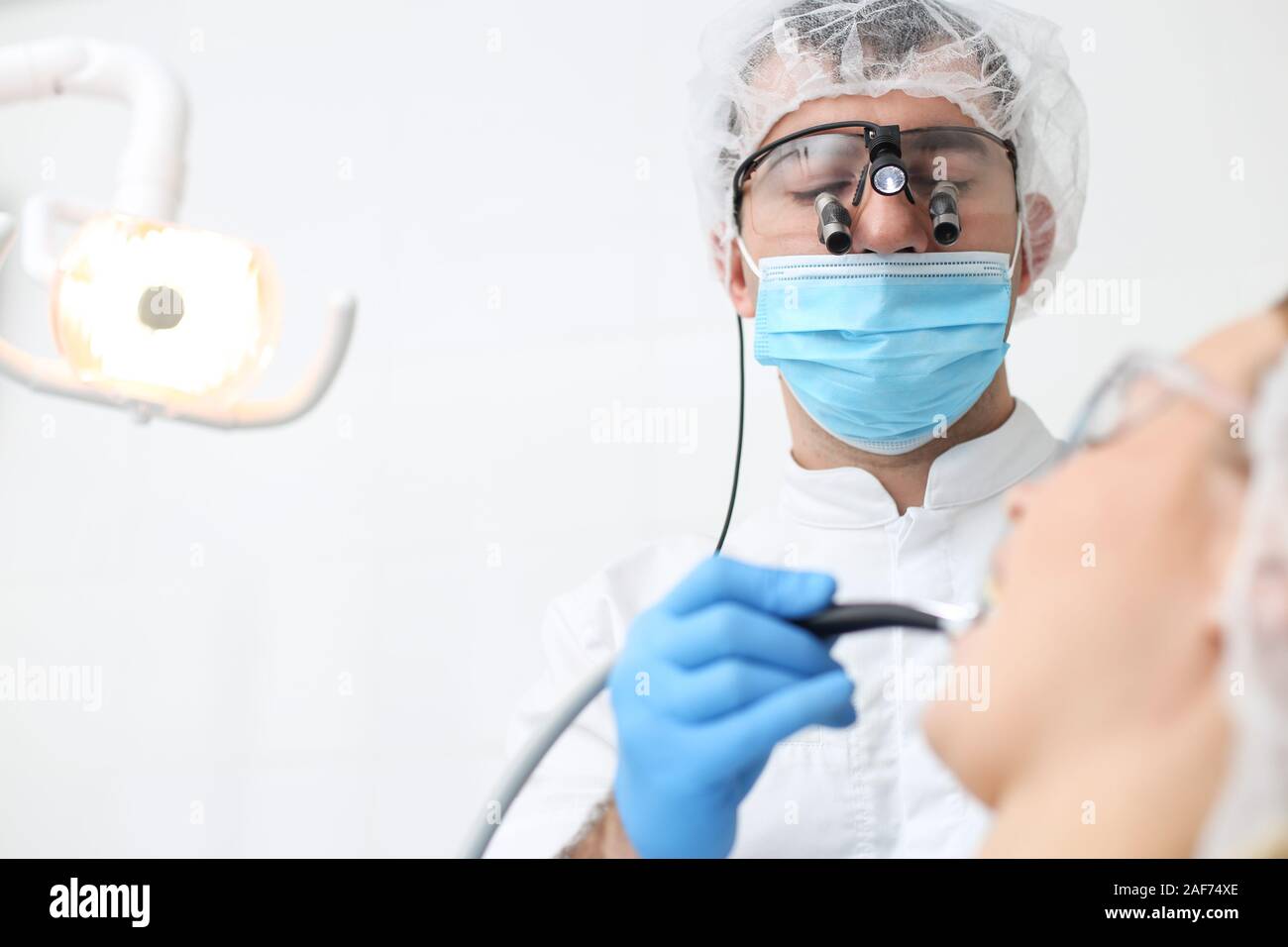 Professional dentist drilling his patient's teeths with dental drill ...