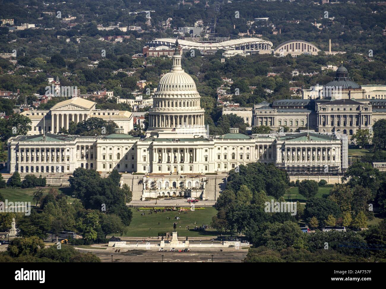 An American flag flutters in the wind in front of the Capitol Building ...