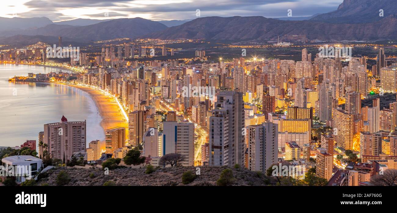 Benidorm Levante beach promenade at sunset with bright reflections in ...
