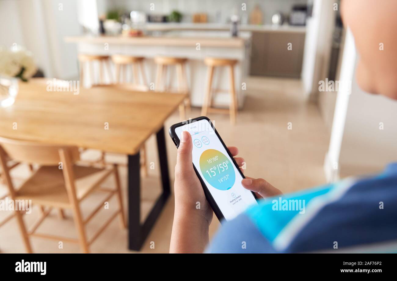 Close Up Of Boy Changing Temperature On Central Heating Thermostat ...