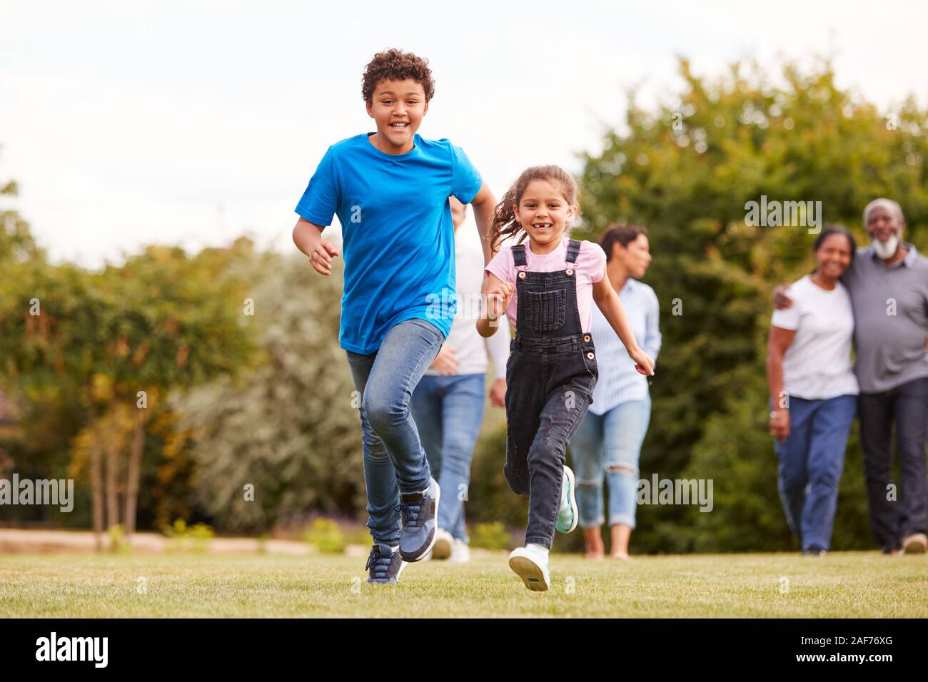Children Running Ahead As Multi-Generation Mixed Race Family Walking In ...