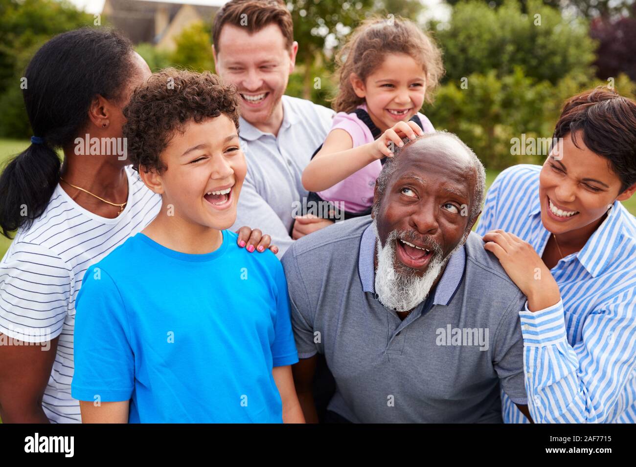 Smiling Multi-Generation Mixed Race Family Having Fun In Garden At Home ...