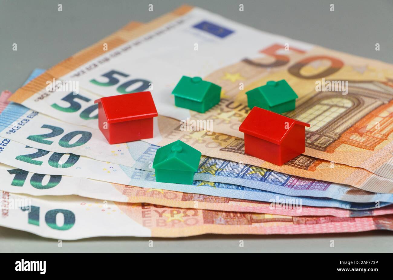 Euro banknotes and small plastic house as concept for the price of ...