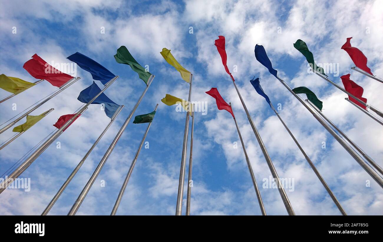 Colorful flags under the blue sky and white clouds Stock Photo - Alamy