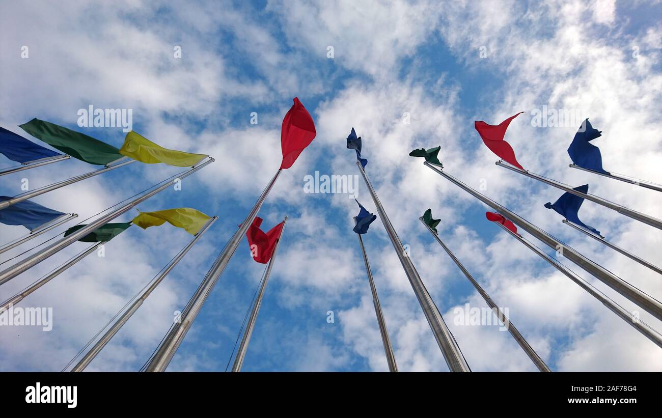 Colorful flags under the blue sky and white clouds Stock Photo - Alamy