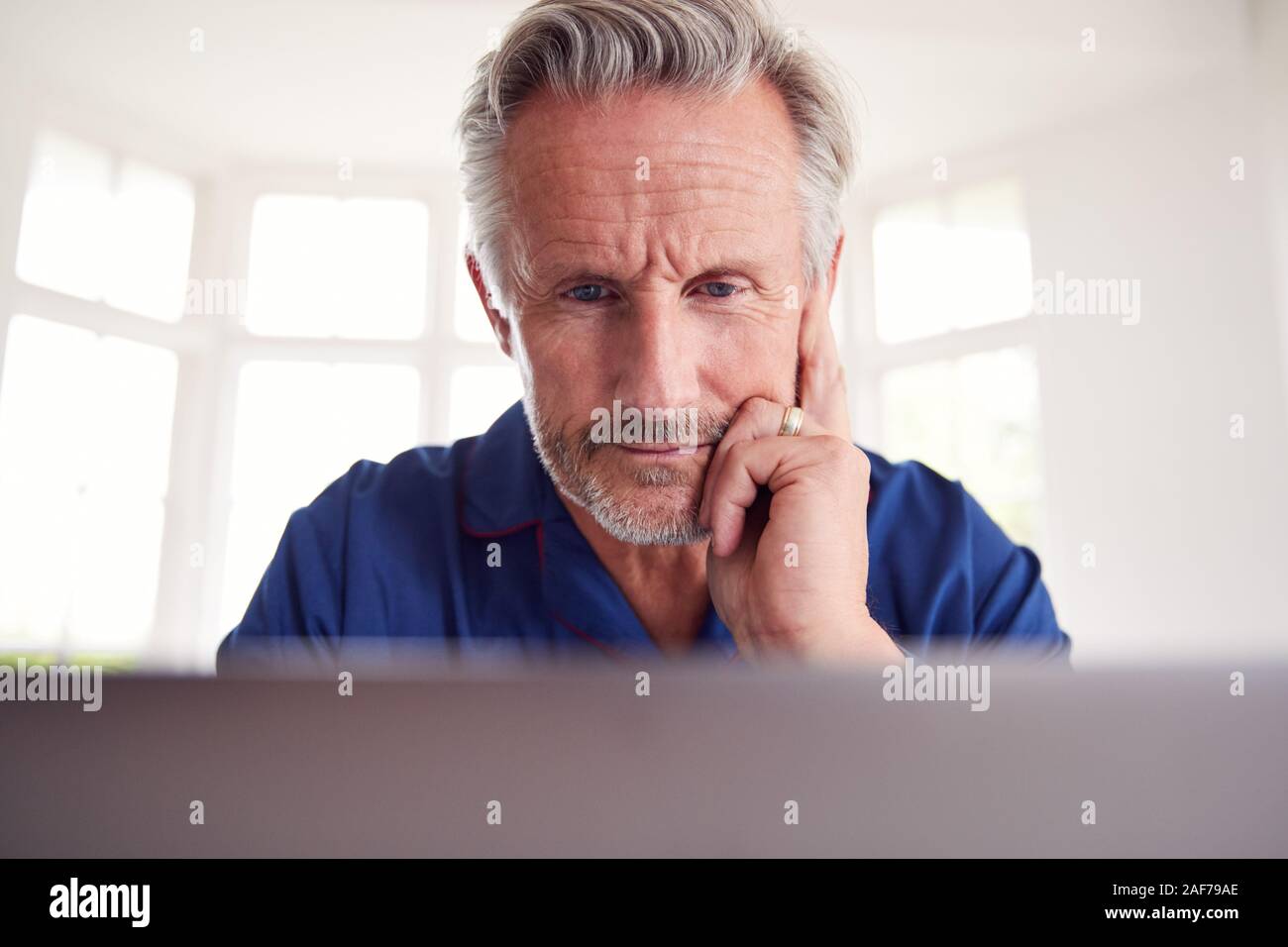 Serious Mature Man Looking Up Information Online Using Laptop Stock ...