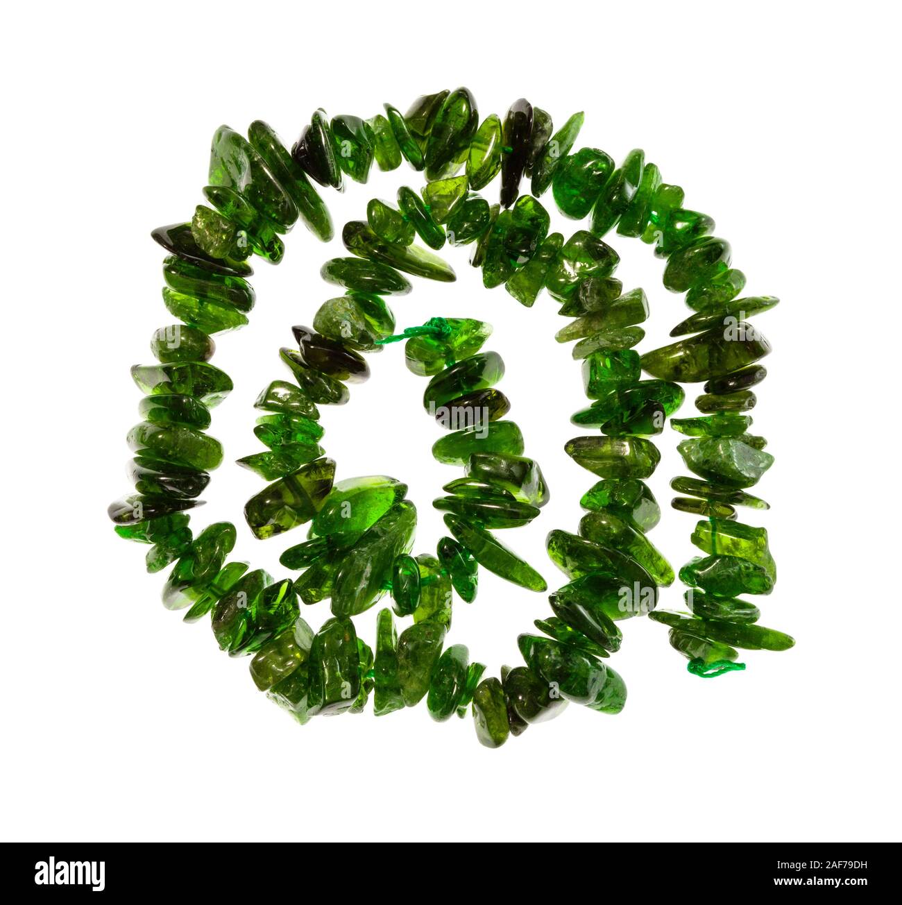 top view of spiral string of beads from natural tumbled chrome diopside gemstone isolated on ...