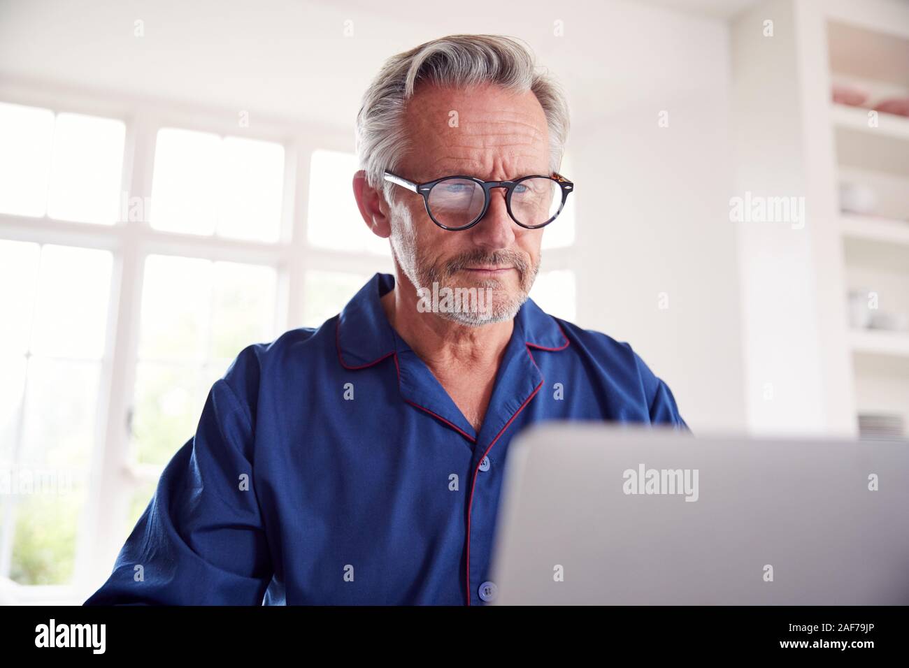 Serious Mature Man Looking Up Information Online Using Laptop Stock ...