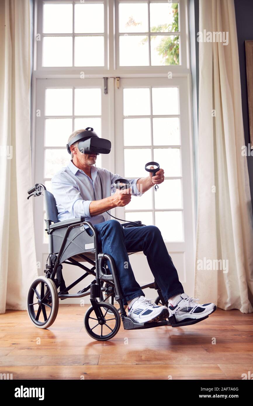 Playing computer game in wheelchair hi-res stock photography and images ...
