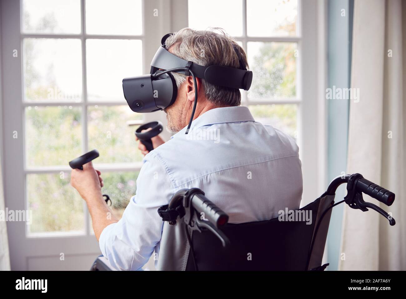 Playing computer game in wheelchair hi-res stock photography and images ...