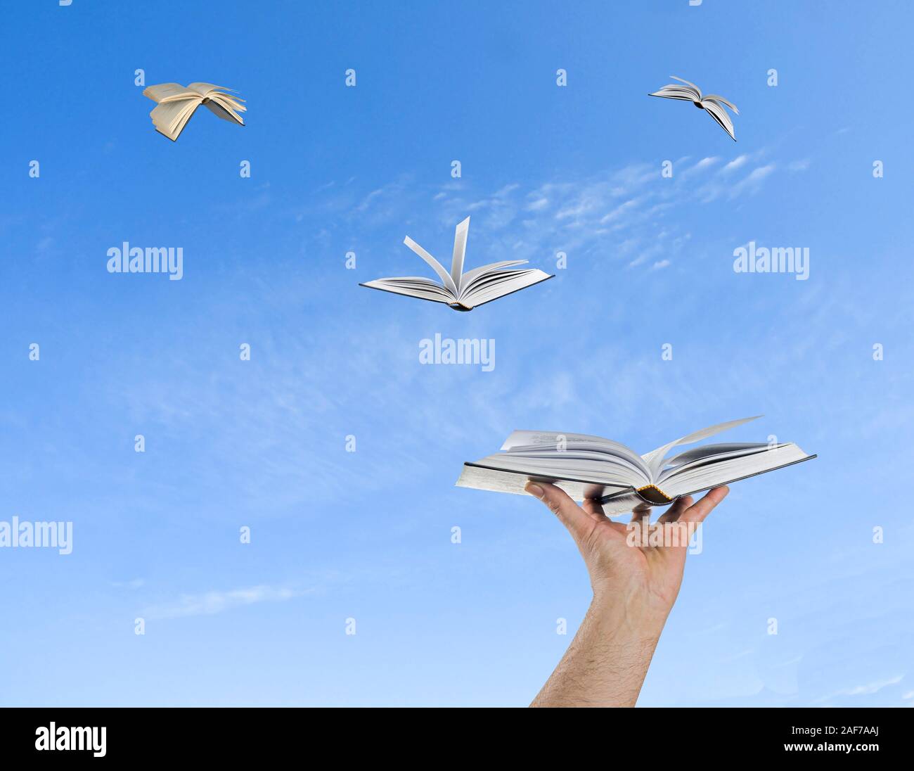Books flying from hands Stock Photo - Alamy