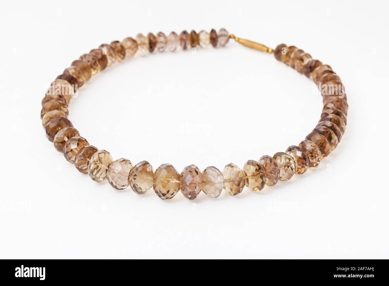 necklace from faceted Smoky quartz gemsones on white paper background ...