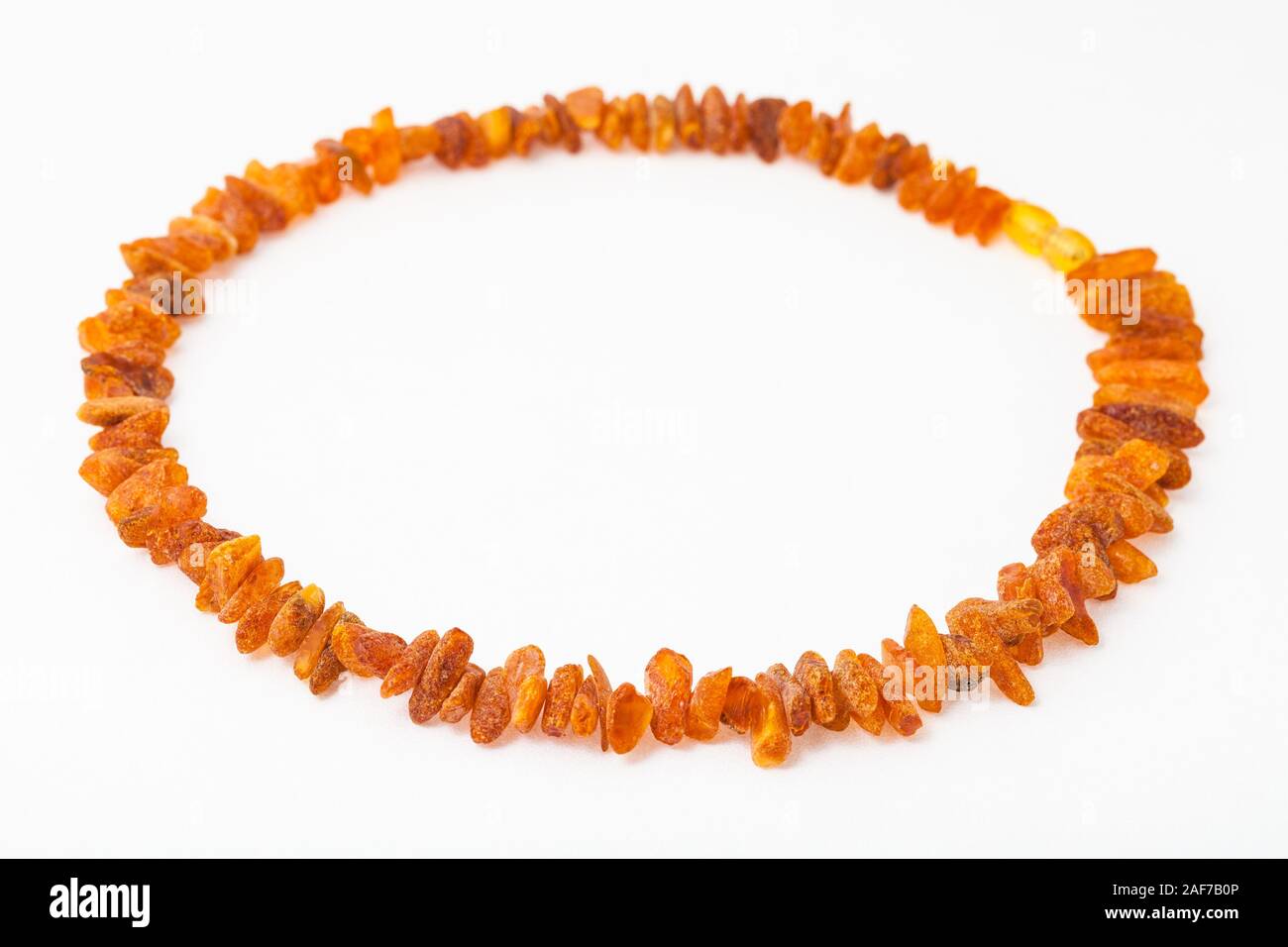 necklace from natural rough amber nuggets on white paper background ...