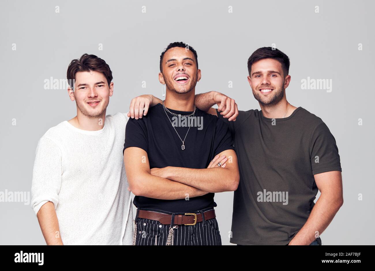 Group Studio Portrait Of Multi-Cultural Male Friends Smiling Into ...