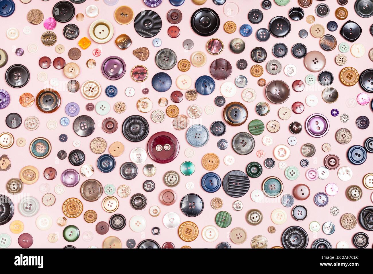 top view of many different buttons on pink background Stock Photo - Alamy
