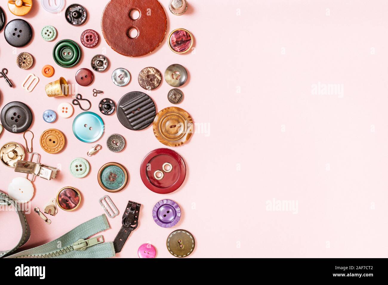 top view of many sewing objects on pink background with blank copyspace ...