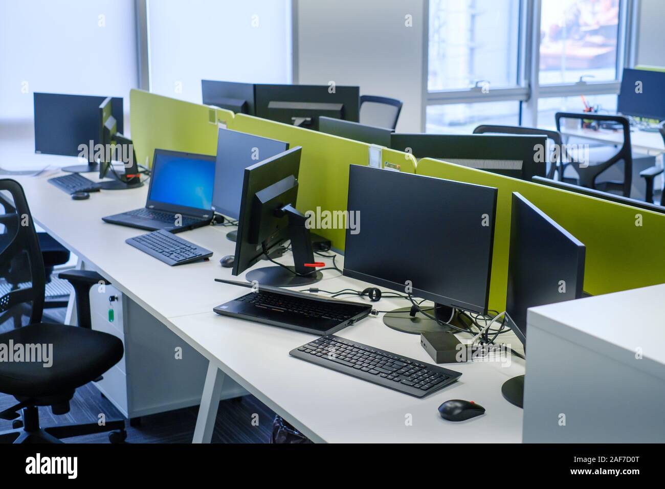 Computer monitors in workplace Stock Photo - Alamy