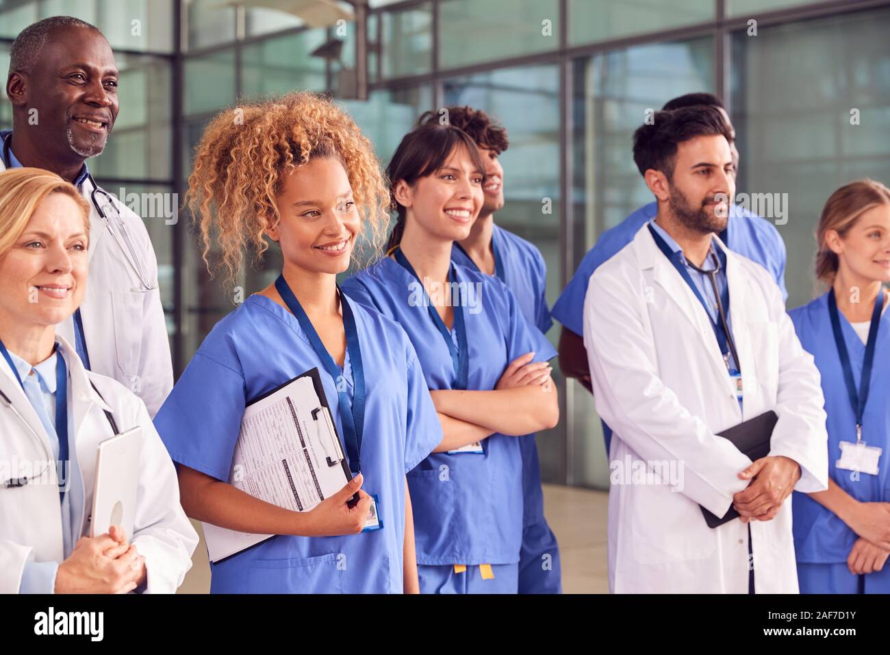 Smiling Medical Team Standing In Modern Hospital Building Stock Photo ...