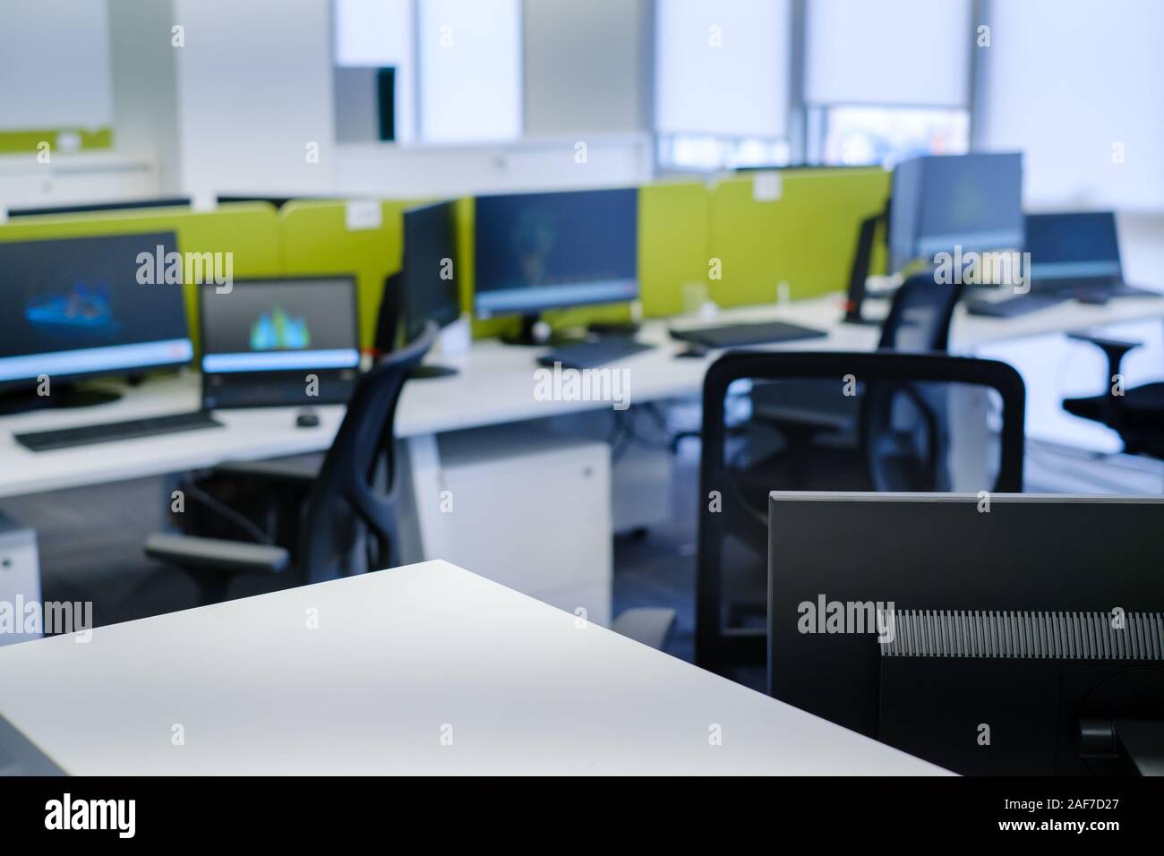 Computer monitors in workplace Stock Photo - Alamy