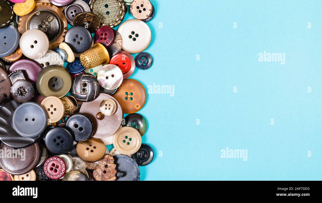 top view of many of various buttons on blue background with blank ...
