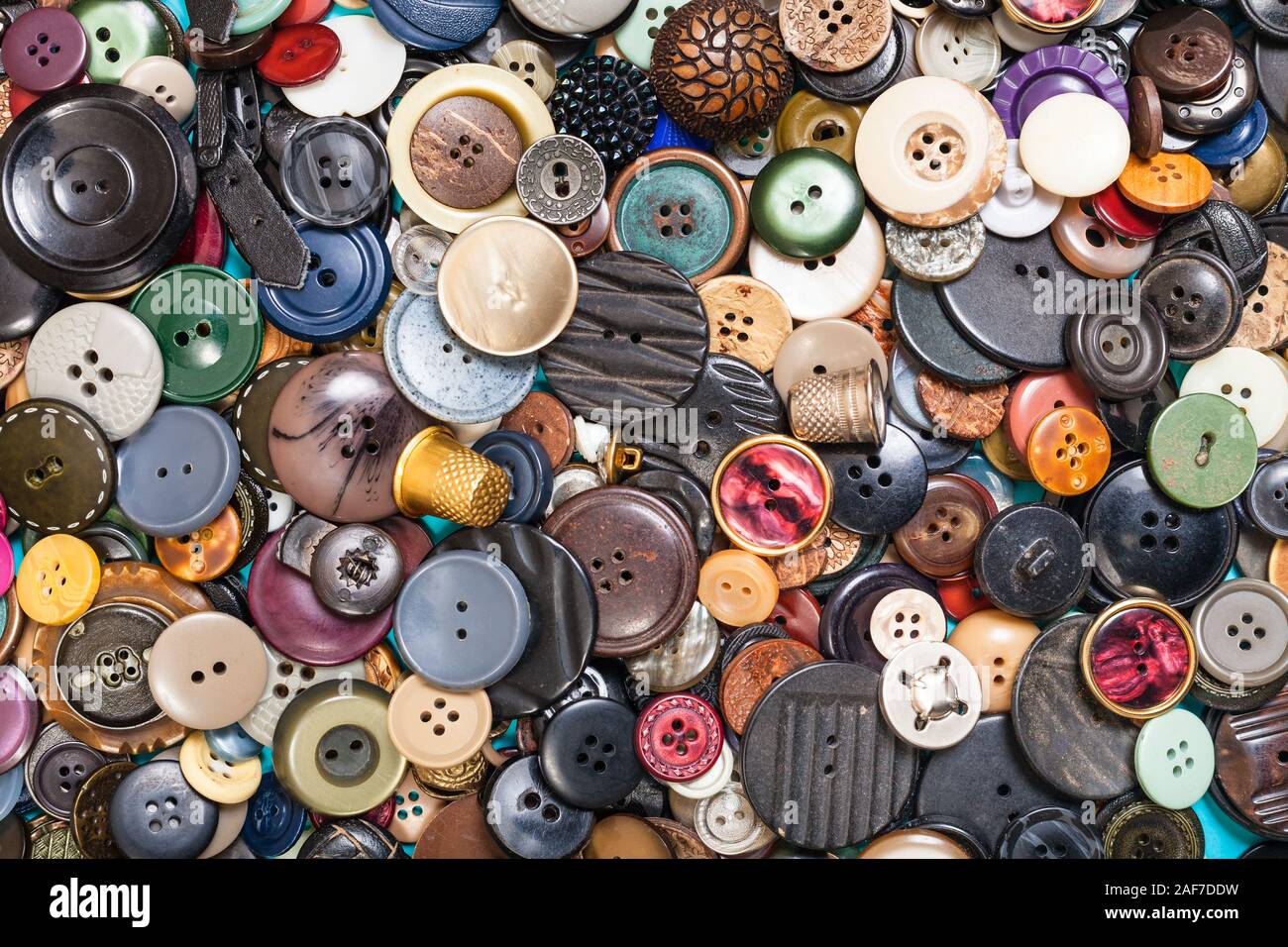 top view of heap of many different buttons close up on blue Stock Photo ...