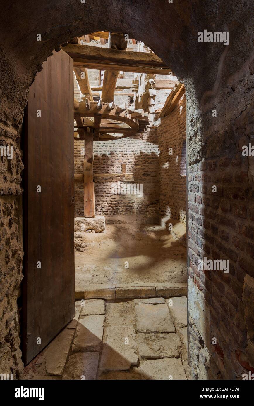 Open grunge door revealing aged water mill turning inside weathered ...