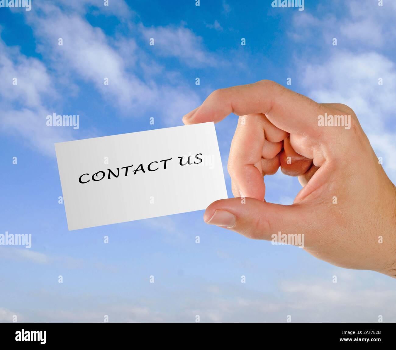 Hand with card CONTACT US Stock Photo - Alamy