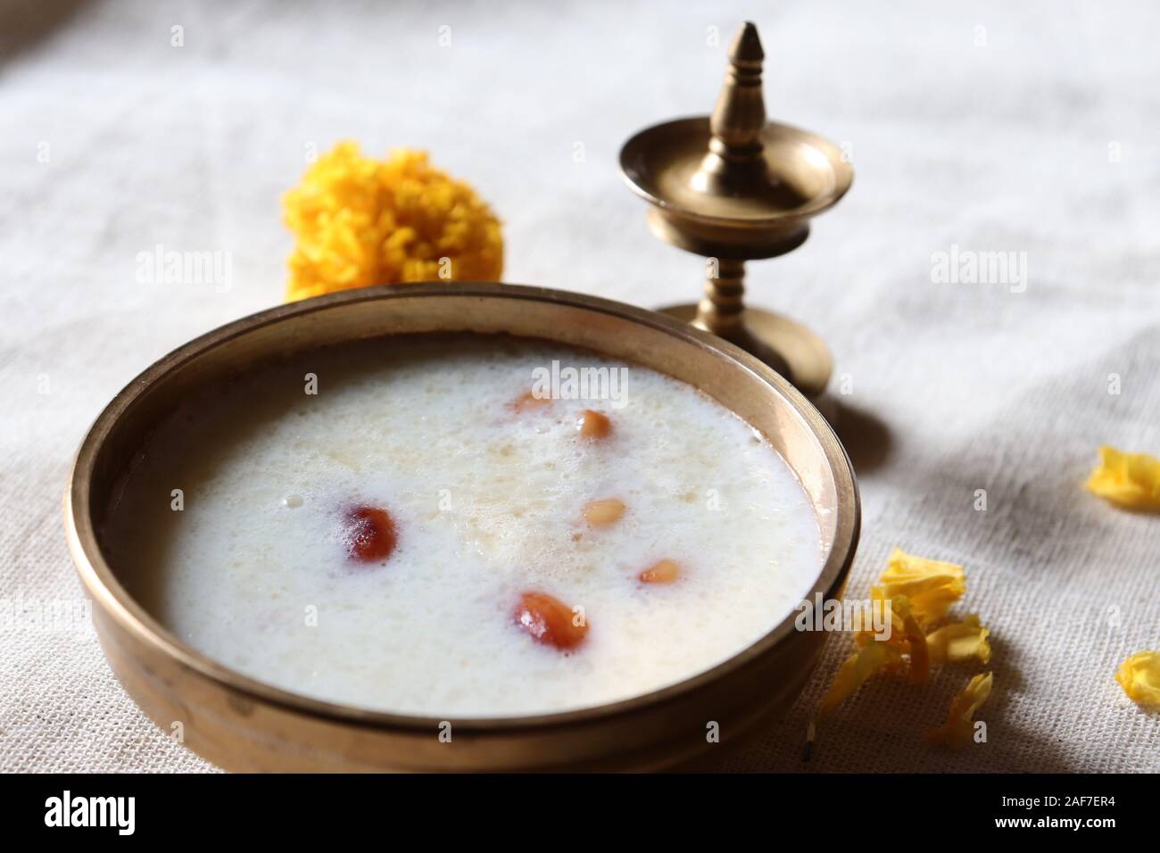 Indian rice pudding/Pal payasam/Kheer in a brass urli with brass oil ...