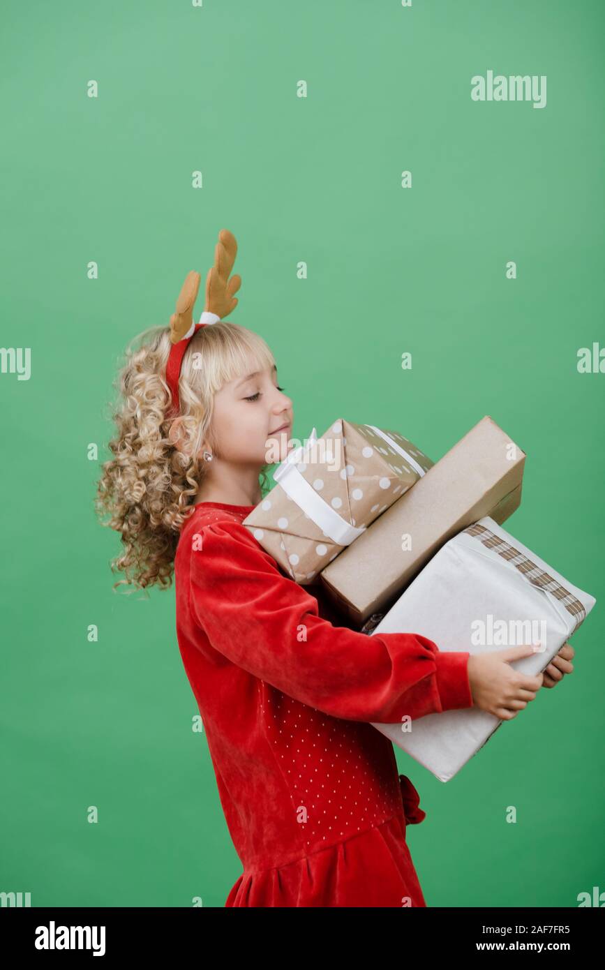 Happy excited child holding christmas gift box. Child giving a ...