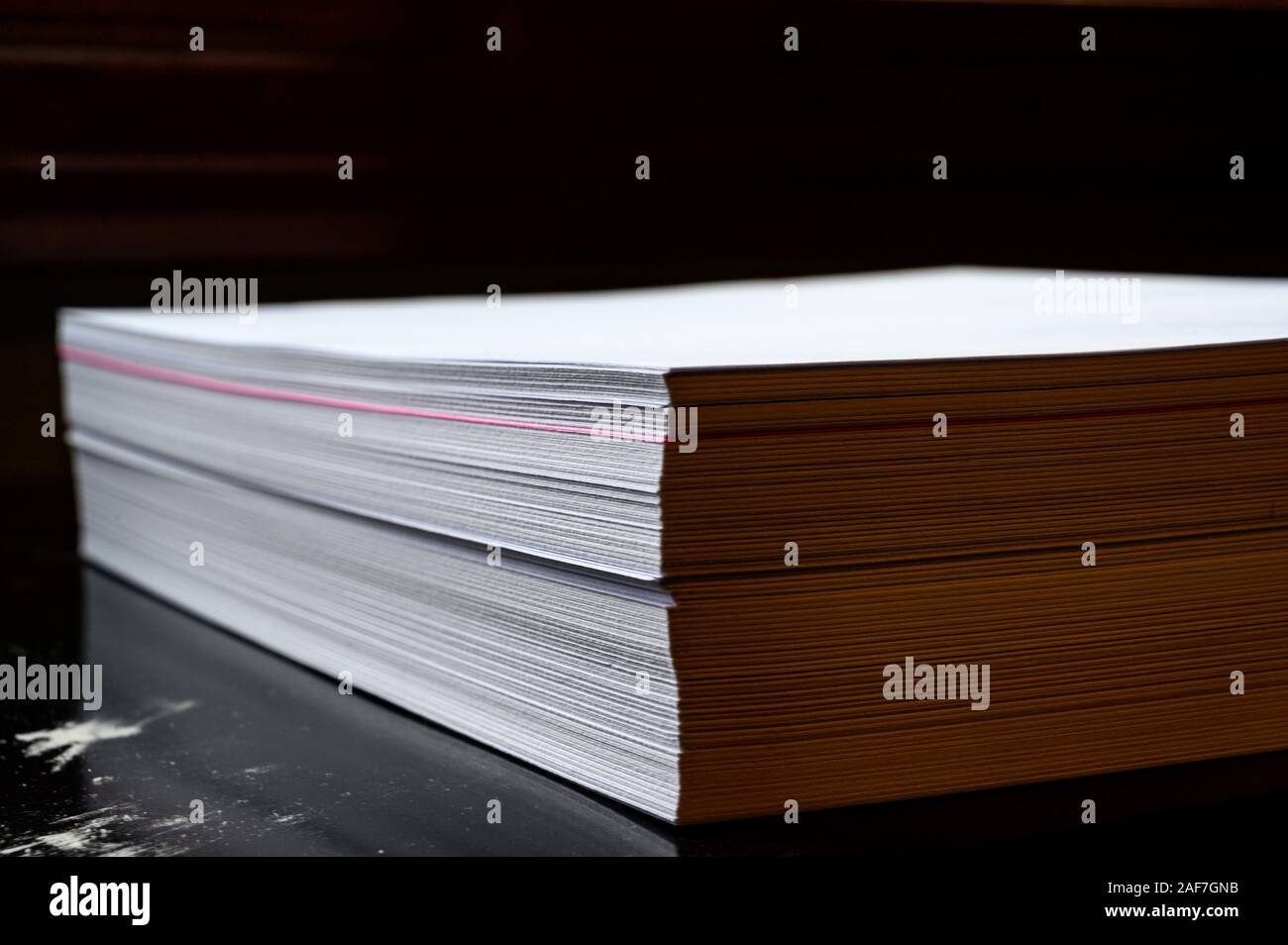Single colored sheet in a stack of plain white paper Stock Photo - Alamy