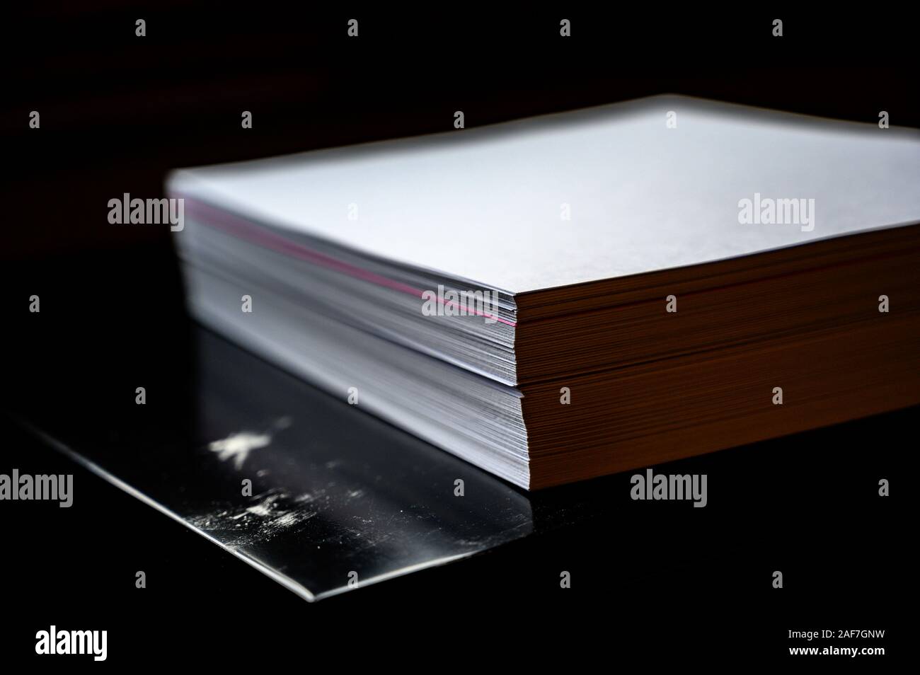 Single colored sheet in a stack of plain white paper Stock Photo - Alamy