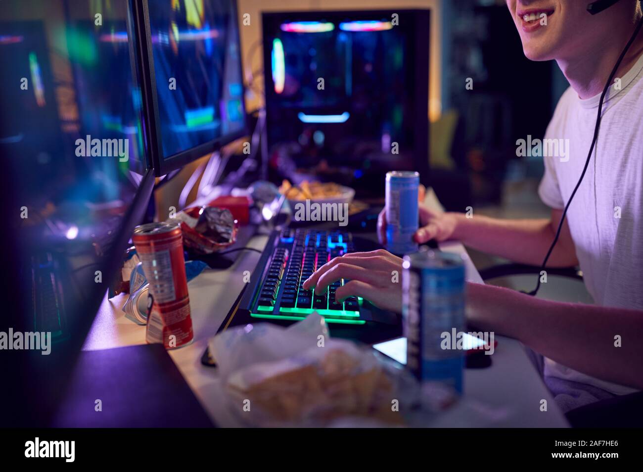 Teenage Boy Drinking Caffeine Energy Drink Gaming At Home Using Dual ...