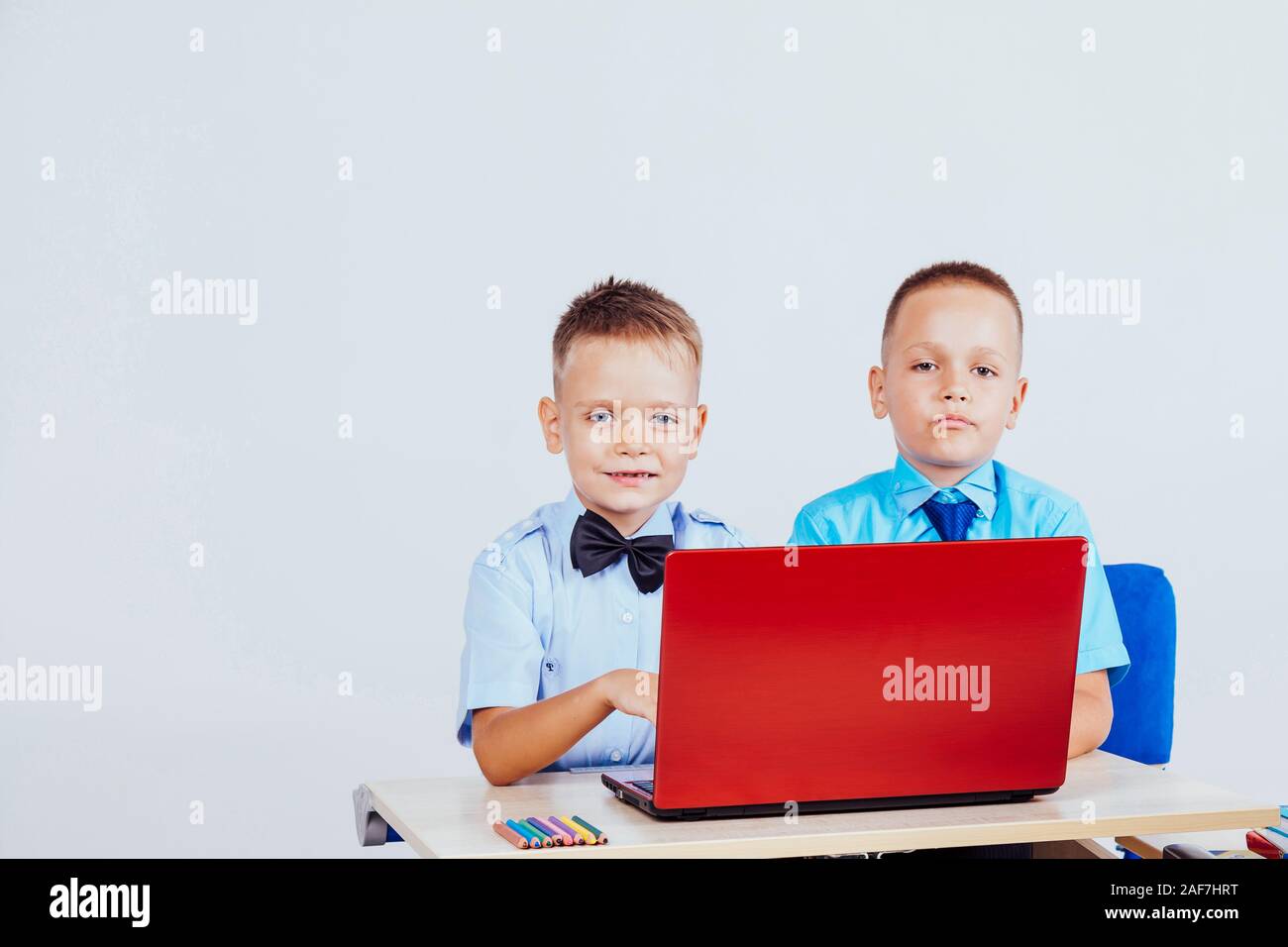 study on the computer two boys at school Stock Photo - Alamy