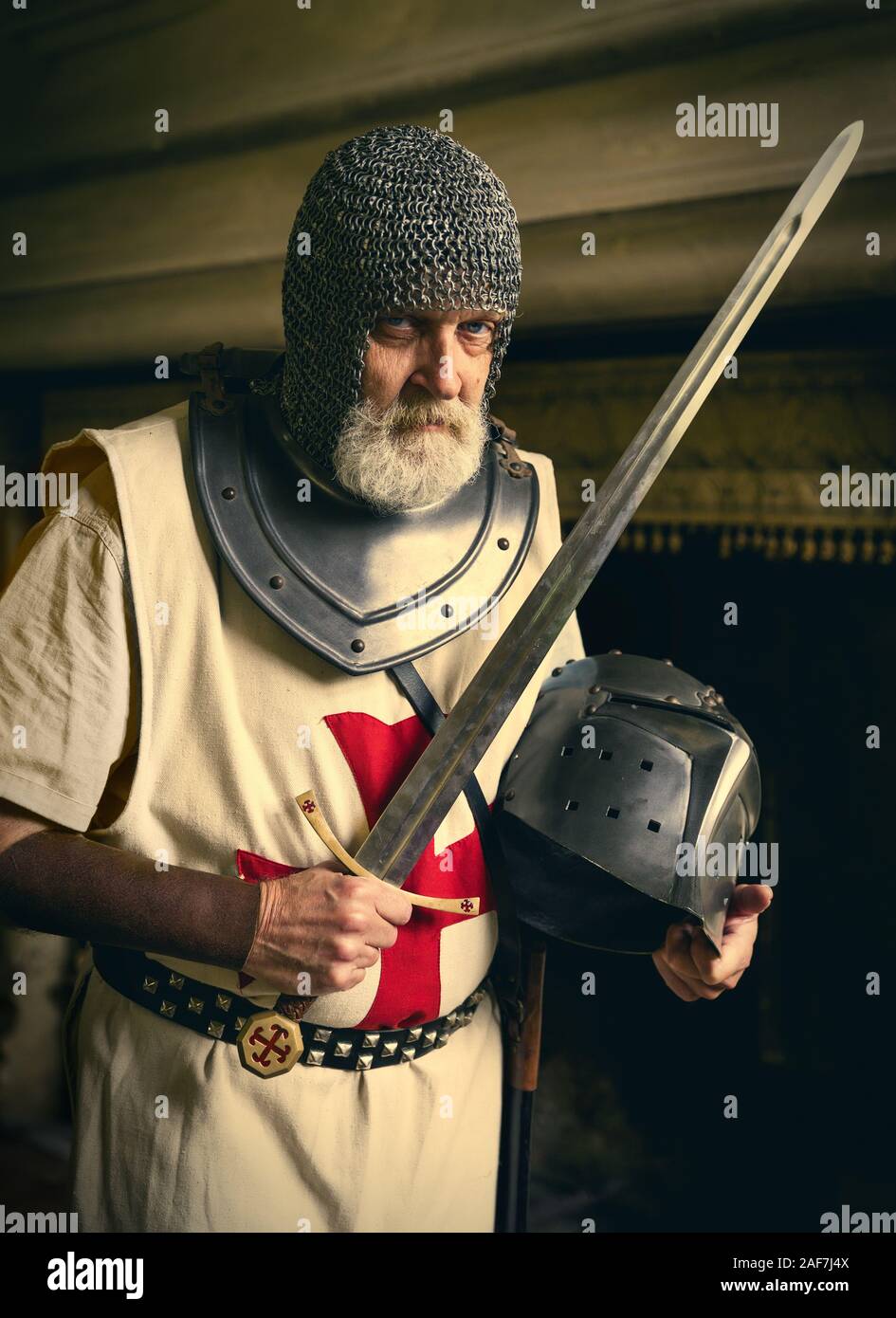 Authentic knight in medieval crusader outfit with helmet, chainmail and ...