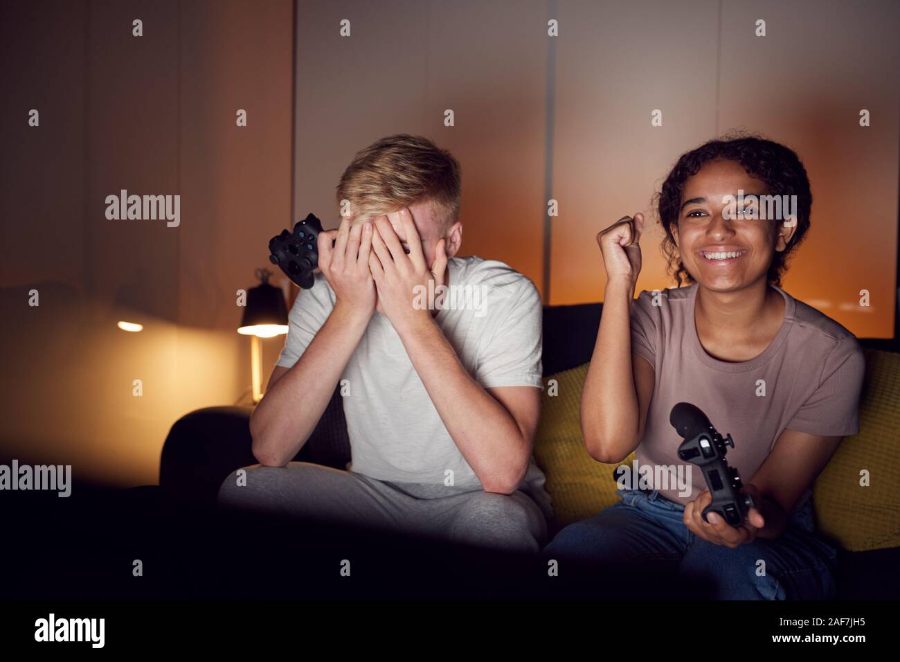 Teen playing video game sofa hi-res stock photography and images - Alamy