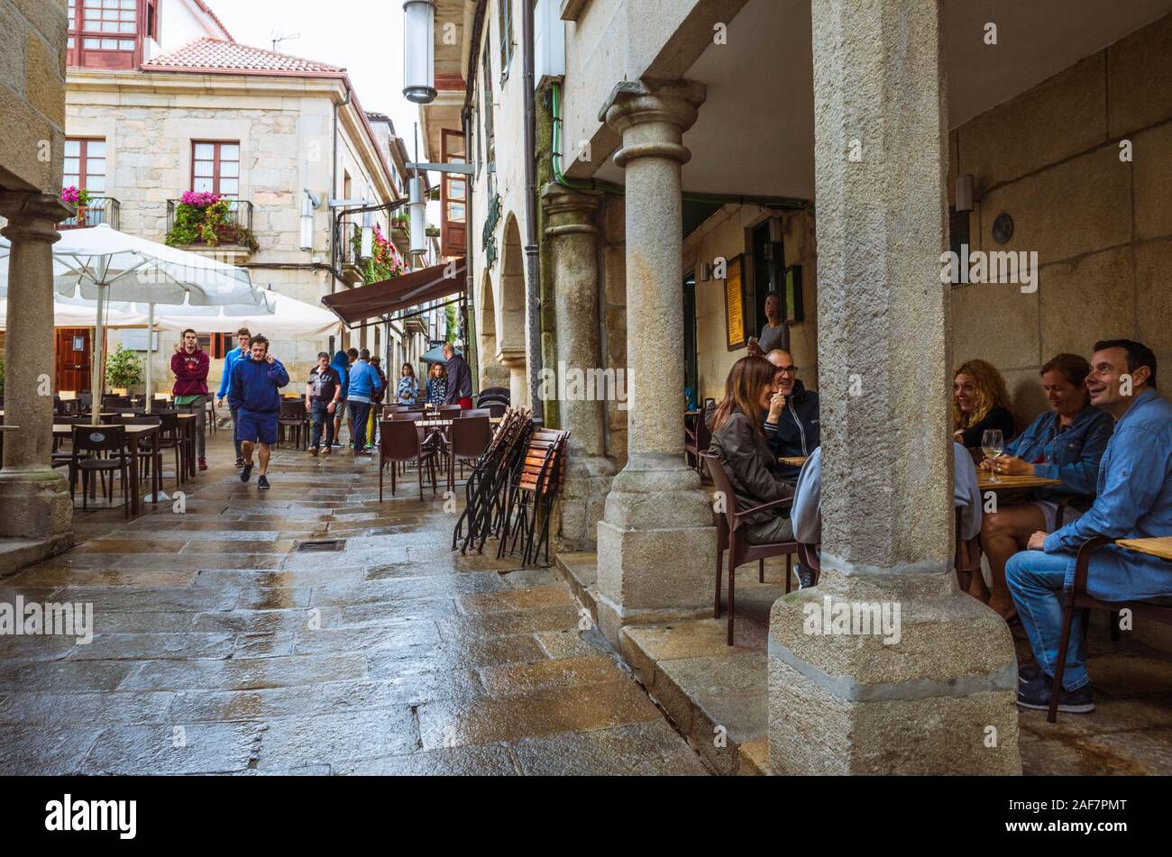 Pontevedra, Galicia, Spain : People sits at an outdoors bar next to ...