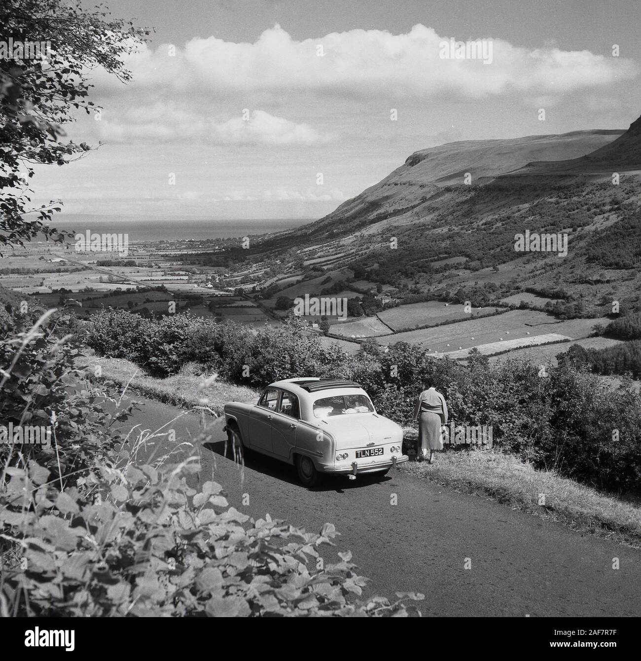 1950s, historical, a lady standing beside her Austin car of the era ...