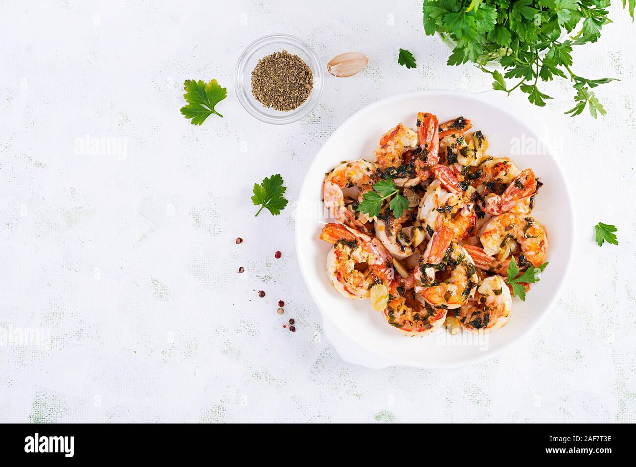 Grilled shrimps. King prawn tails in orange-garlic sauce with parsley ...