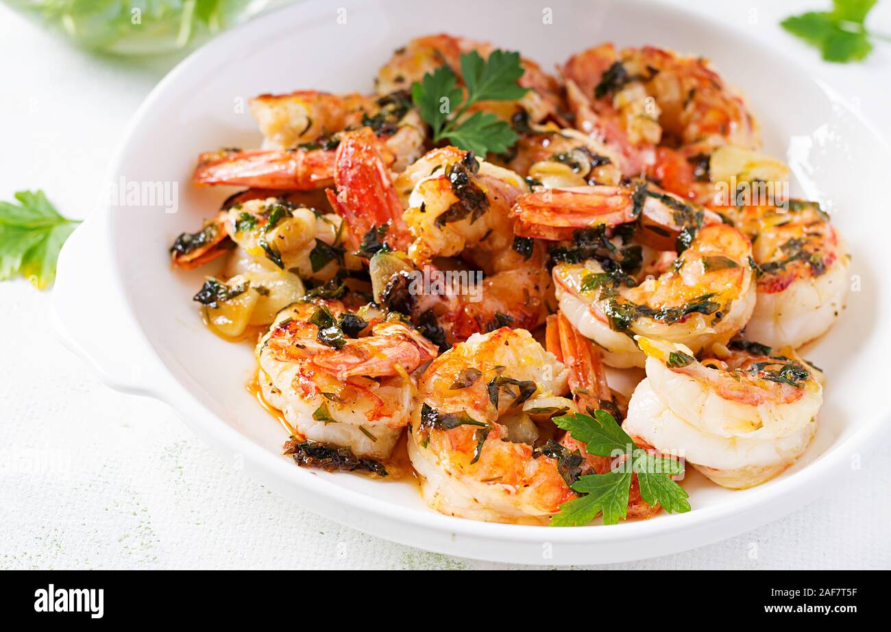 Grilled shrimps. King prawn tails in orange-garlic sauce with parsley ...