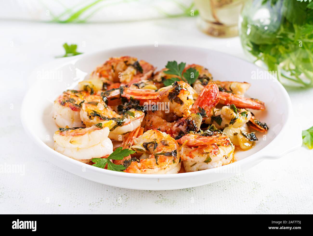 Grilled shrimps. King prawn tails in orange-garlic sauce with parsley ...