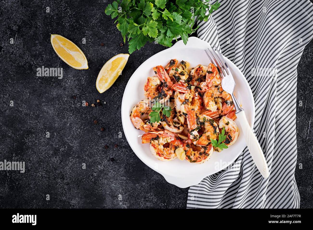 Grilled shrimps. King prawn tails in orange-garlic sauce with parsley ...