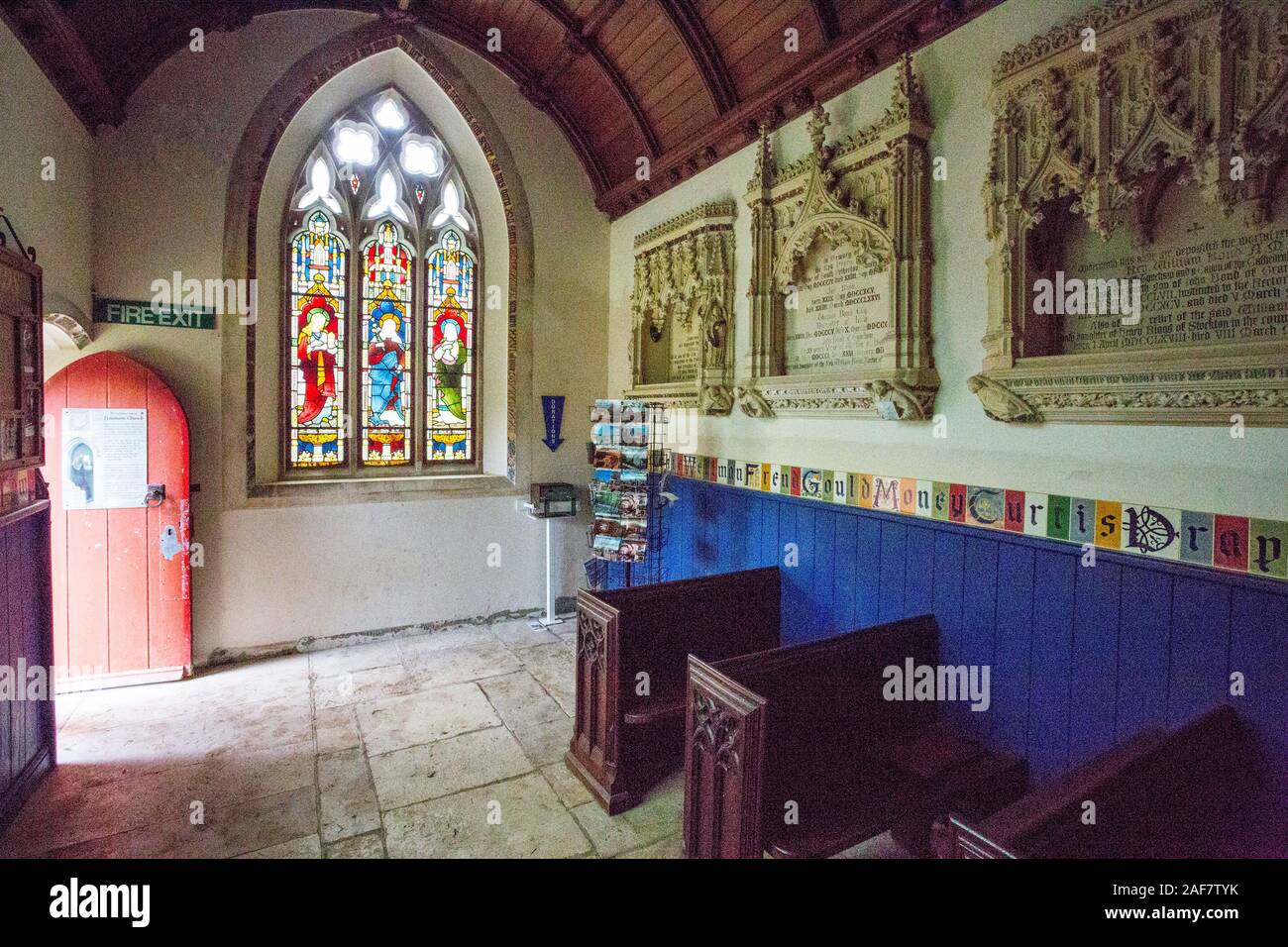 Some of the preserved pews and stained glass window inside the parish ...