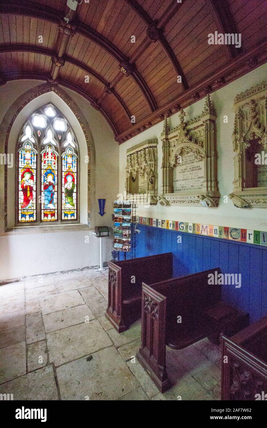 Some of the preserved pews and stained glass window inside the parish ...