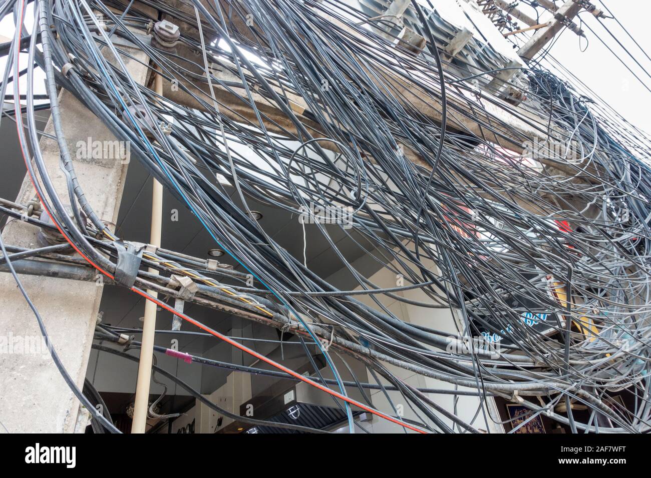Chaotic electricity supply, hundreds of wires around poles Stock Photo ...