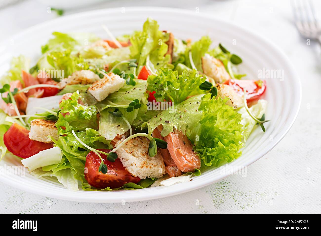 Caesar Salad with Salmon. Fish menu. Seafood - salmon Stock Photo - Alamy