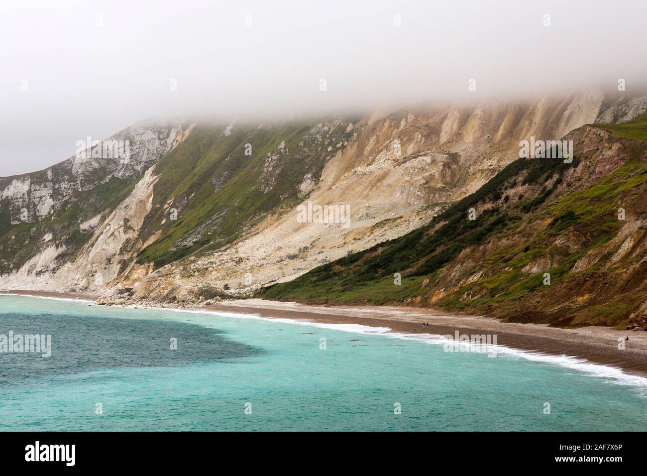 Low cloud partly obscures the full extent of a massive chalk cliff fall ...