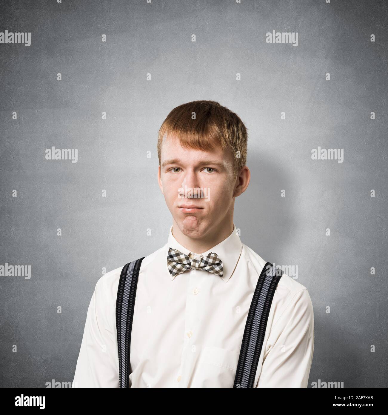 Unhappy young man looking at camera. Emotional redhead boy has ...