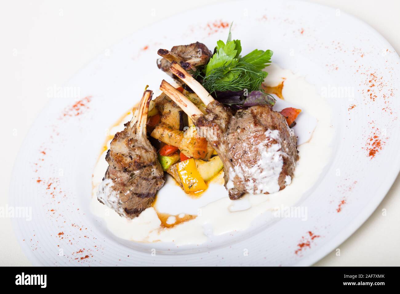 Grilled rack of lamb with cheese sauce and vegetable garnish Stock ...